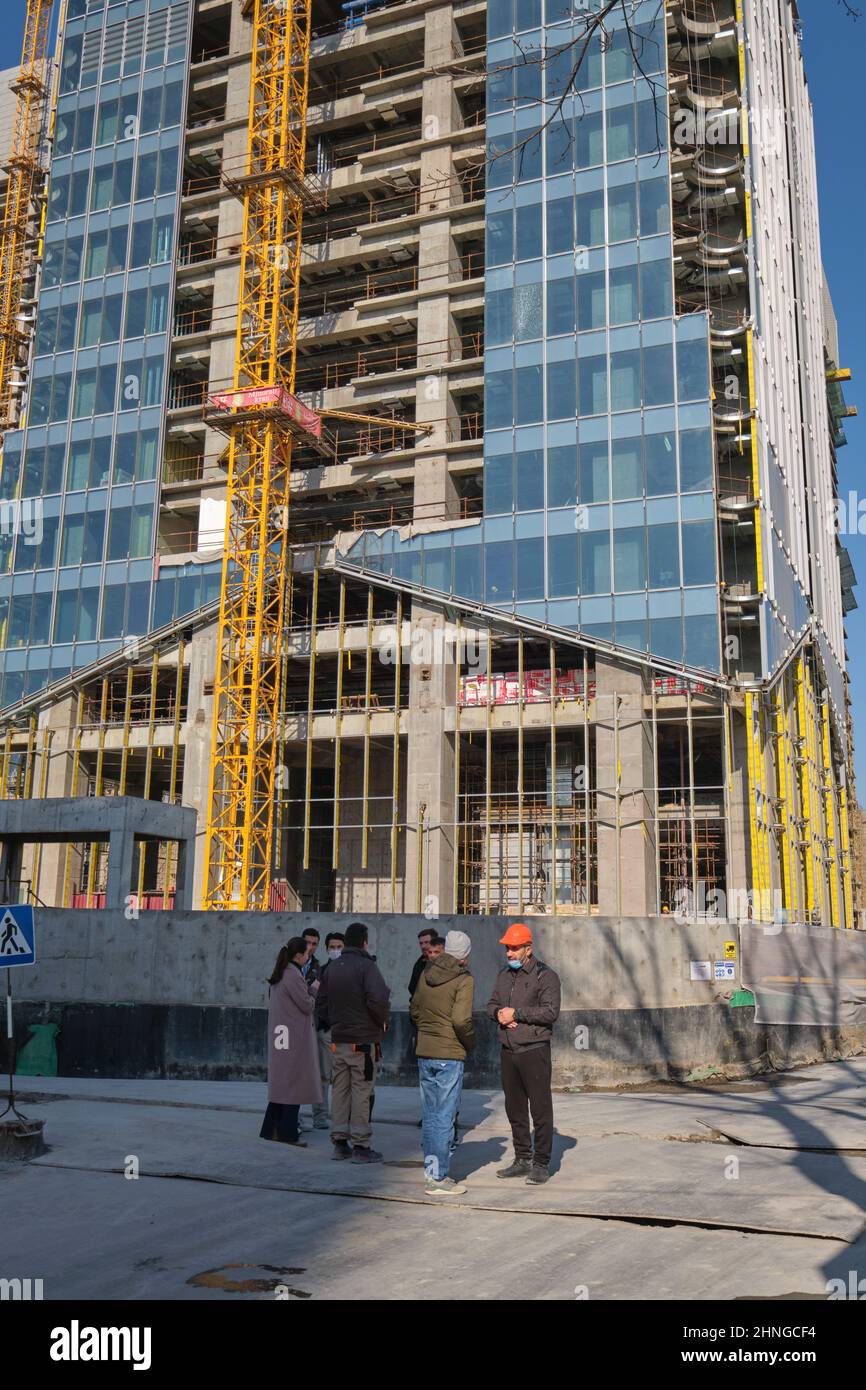 Tall, modern, glass office towers under construciton. At the downtown ...