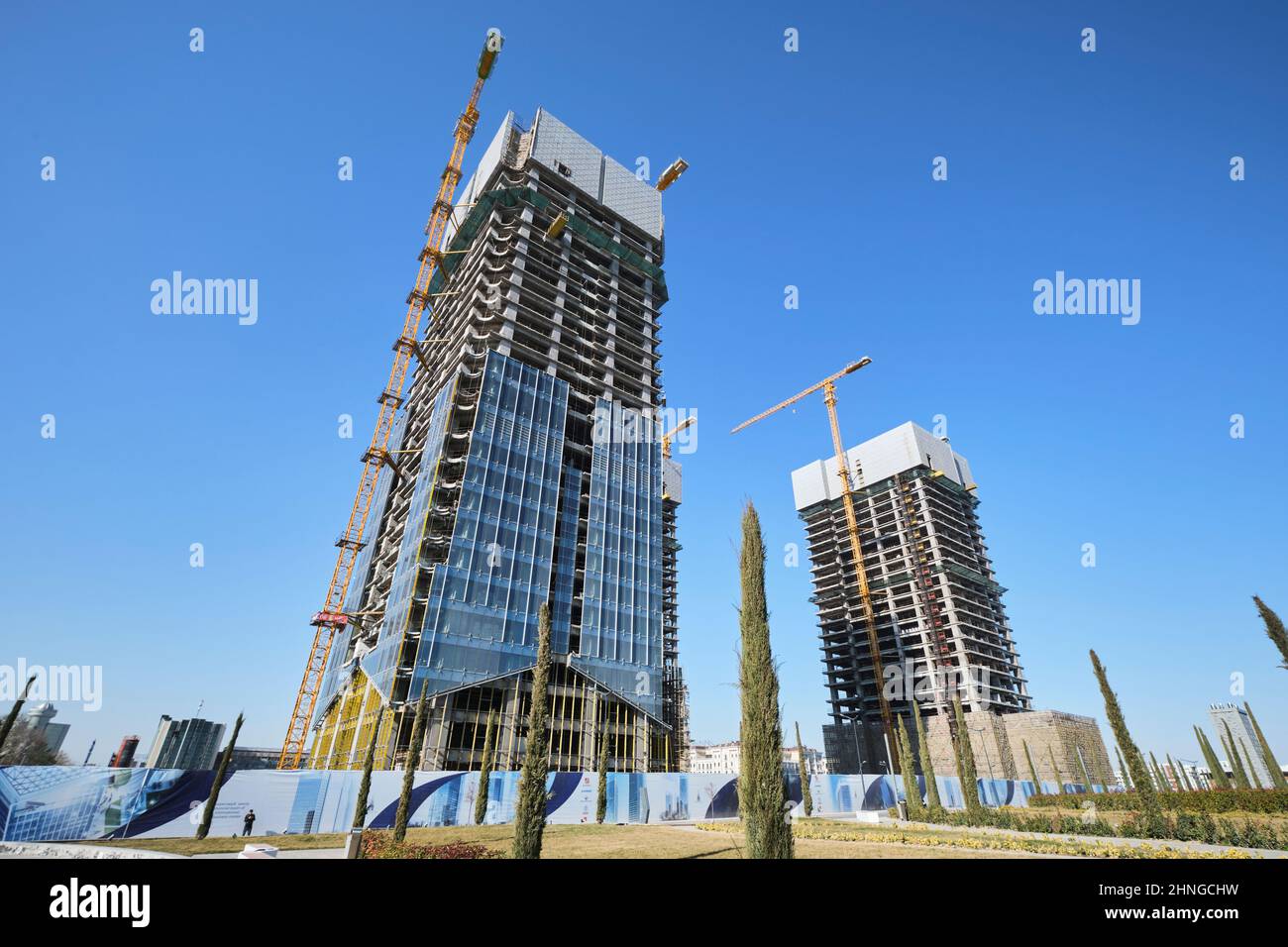 Tall, modern, glass office towers under construciton. At the downtown ...