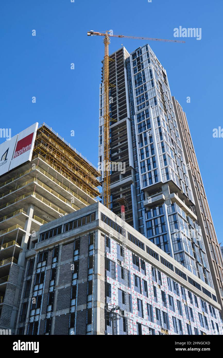 Tall, modern, glass office towers under construciton. At the downtown ...