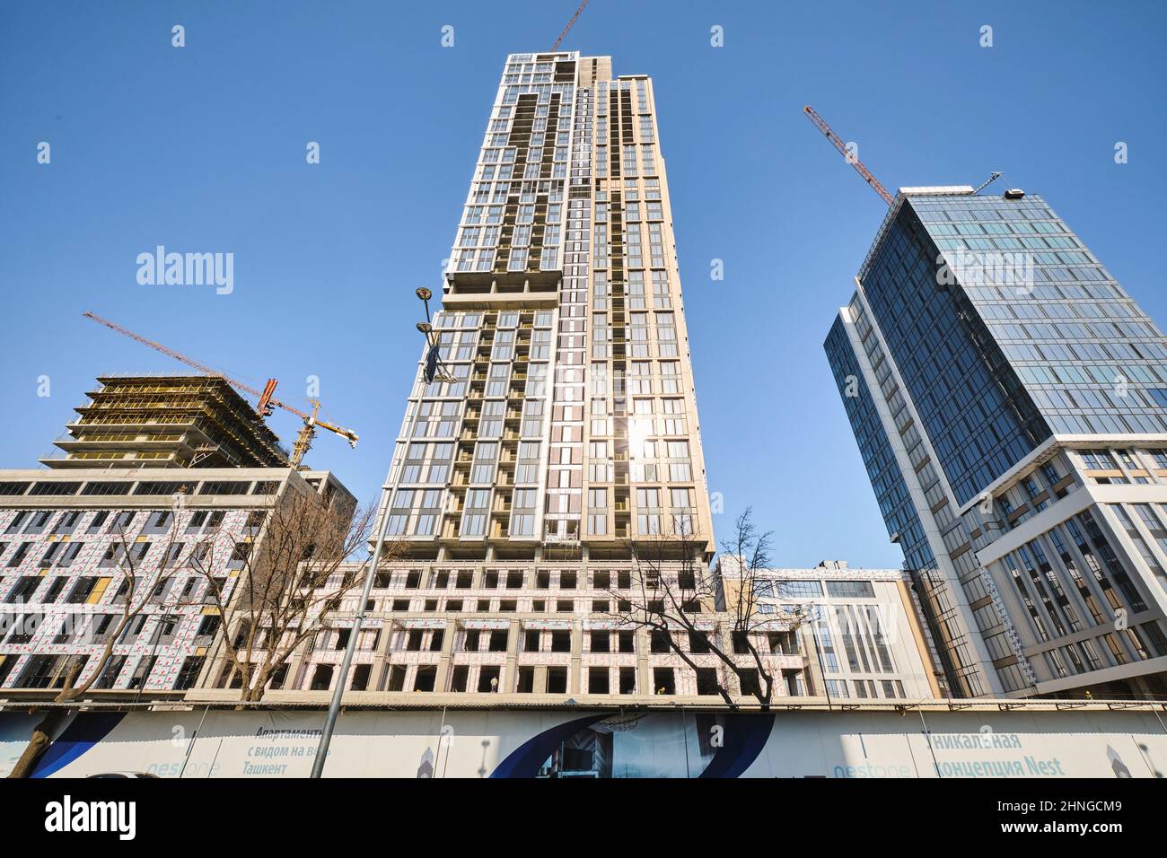 Tall, modern, glass office towers under construciton. At the downtown ...