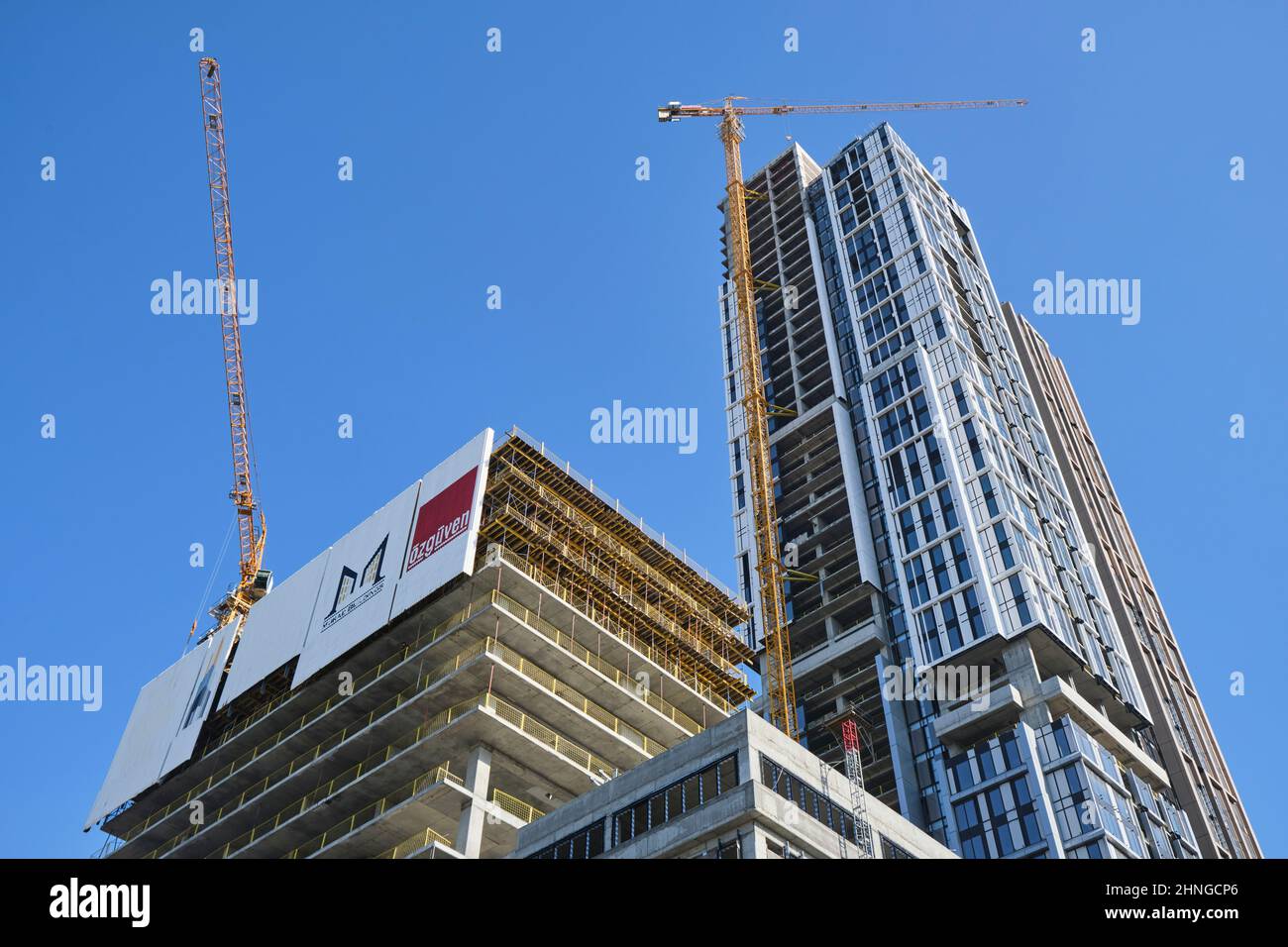 Tall, modern, glass office towers under construciton. At the downtown ...