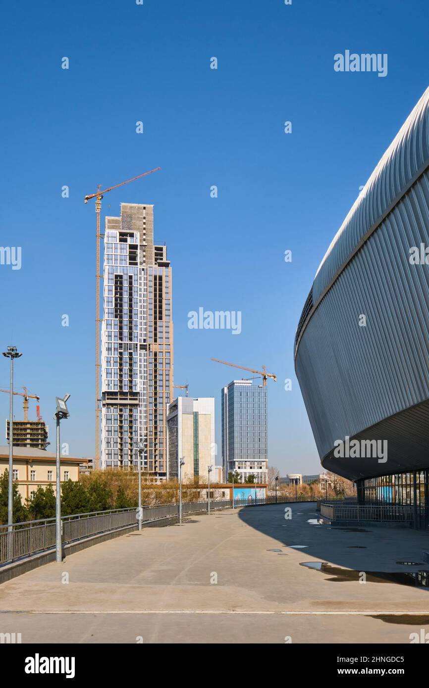 Office tower construciton near the futuristic, round, spaceship looking ...
