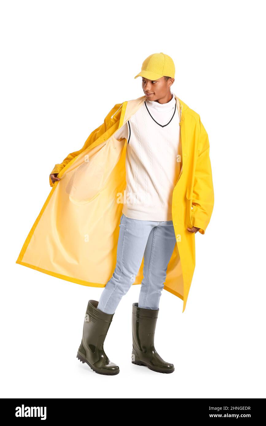 Handsome stylish African-American guy in raincoat on white background ...