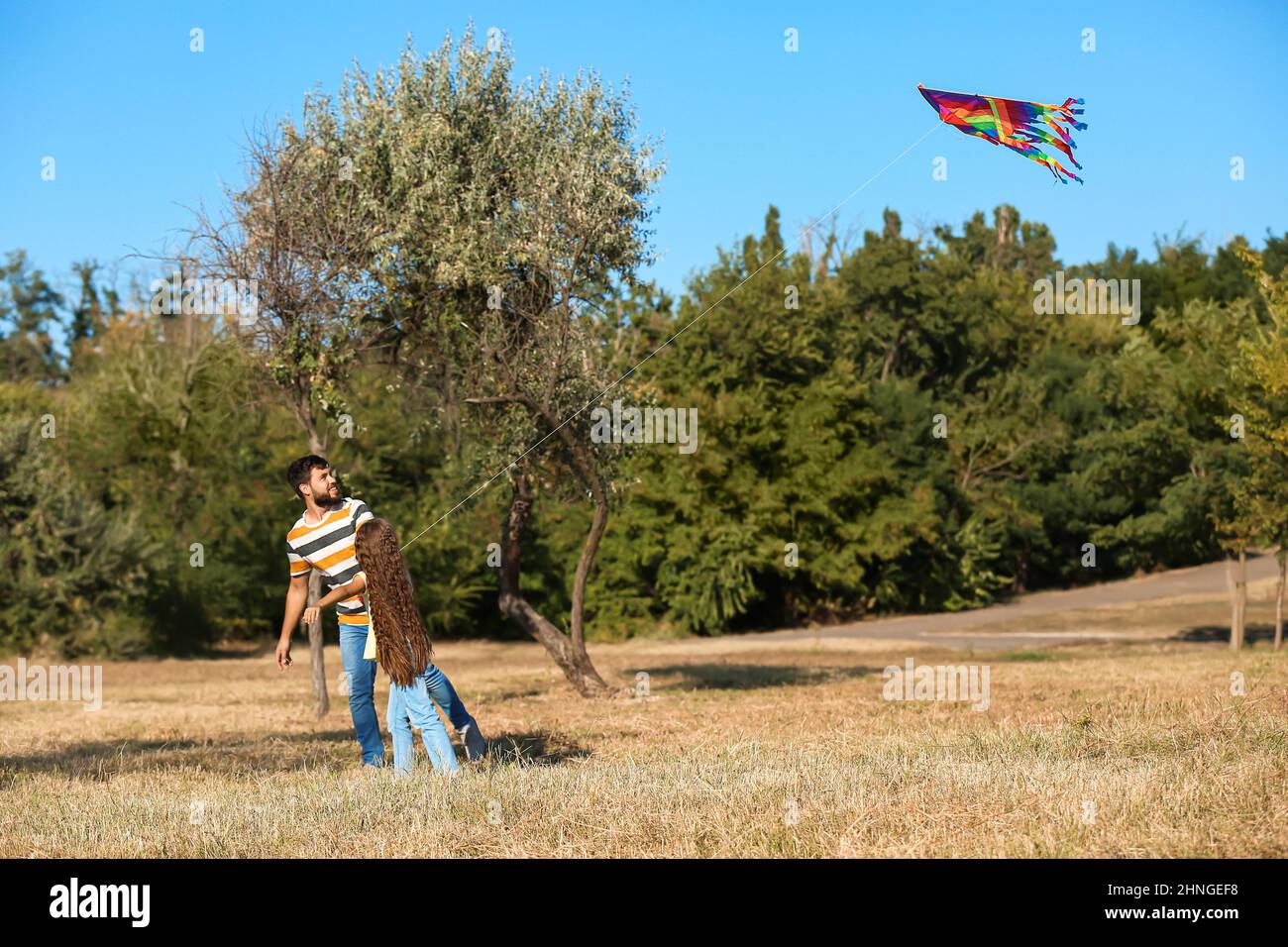 Little girl with her father flying kite outdoors Stock Photo - Alamy