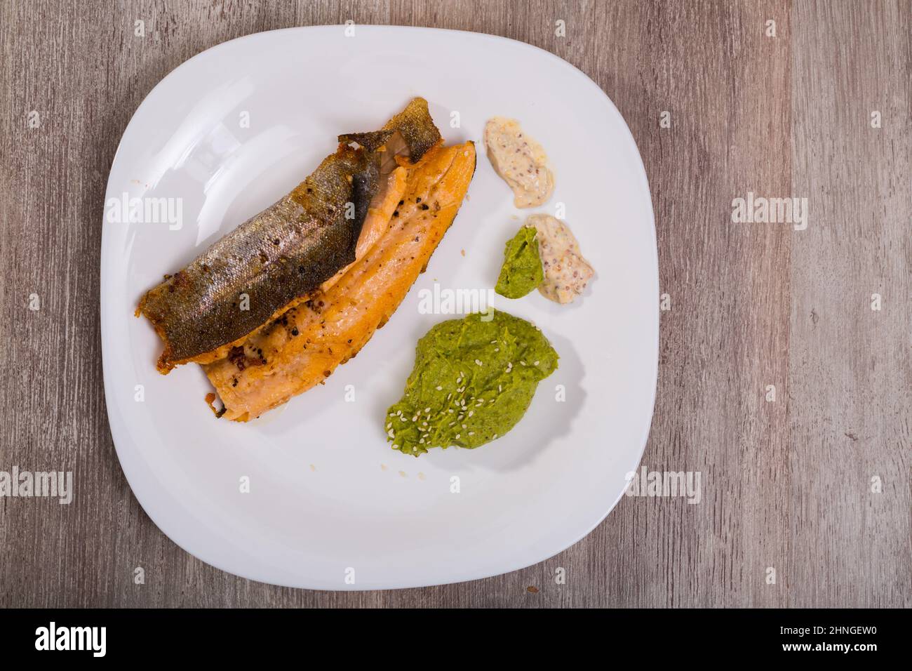 Top view of fried trout fillets with broccoli puree Stock Photo - Alamy