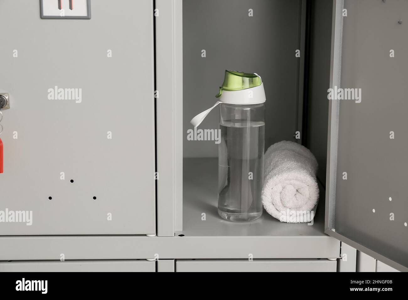 Bottle of water and towel in locker Stock Photo - Alamy