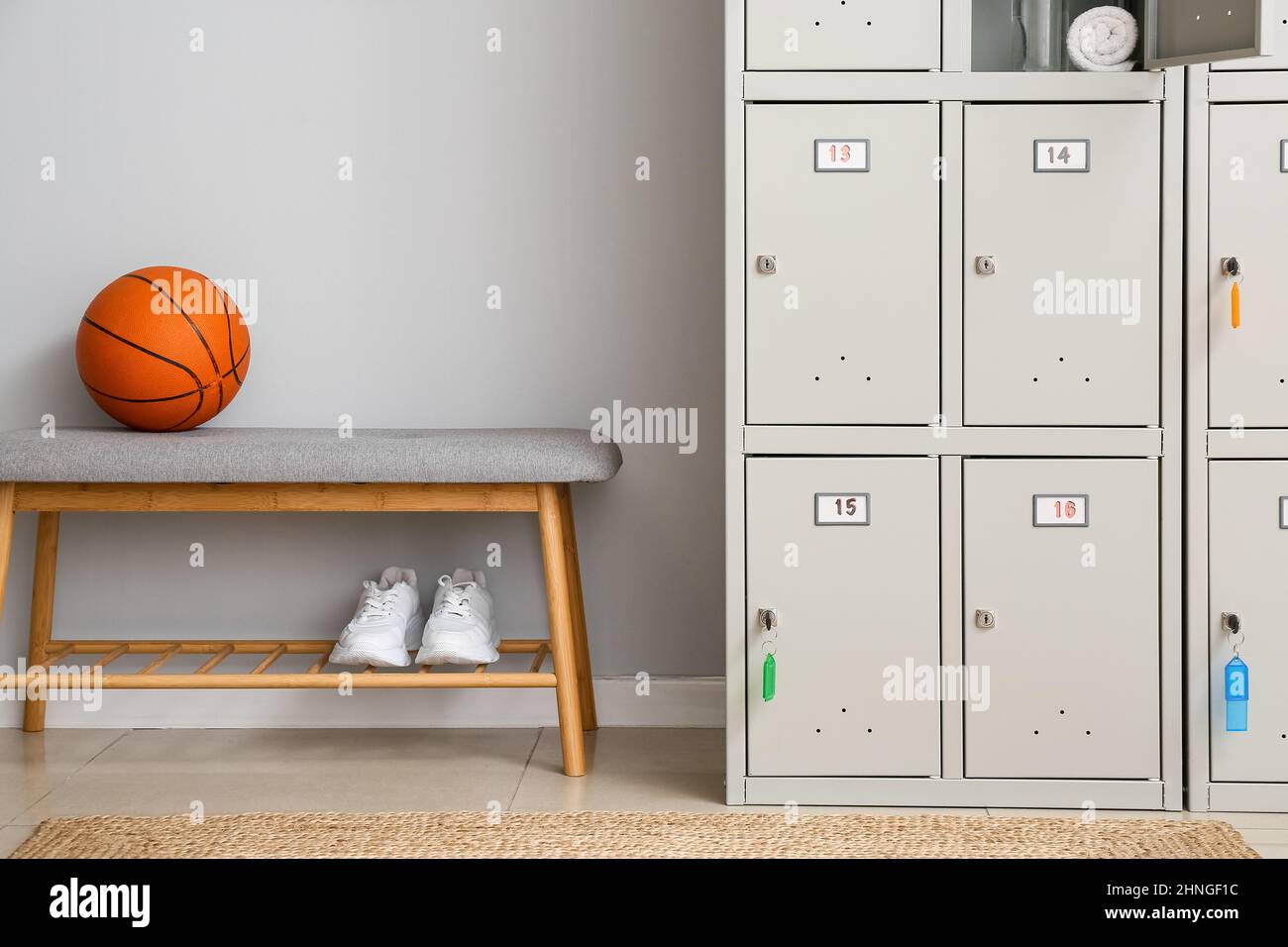 Locker with sport equipment and bench in change-room Stock Photo - Alamy