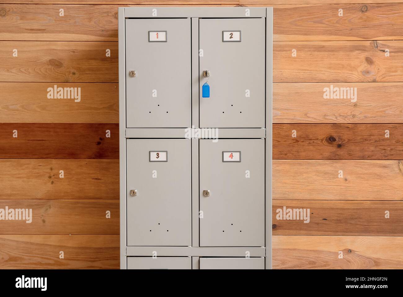 Modern locker near wooden wall Stock Photo - Alamy