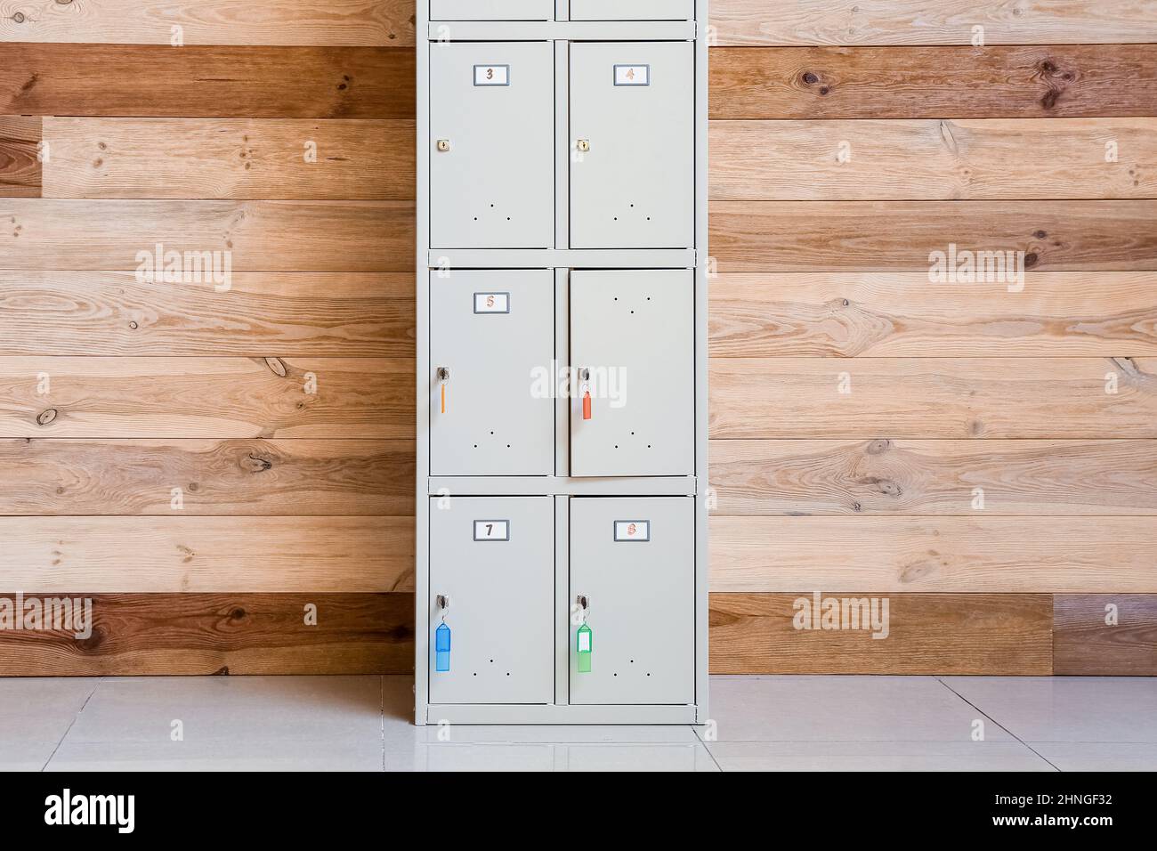 Modern locker near wooden wall Stock Photo - Alamy