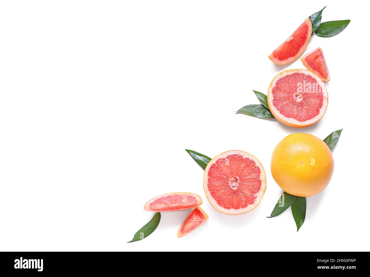Fresh grapefruit pieces on white background Stock Photo - Alamy