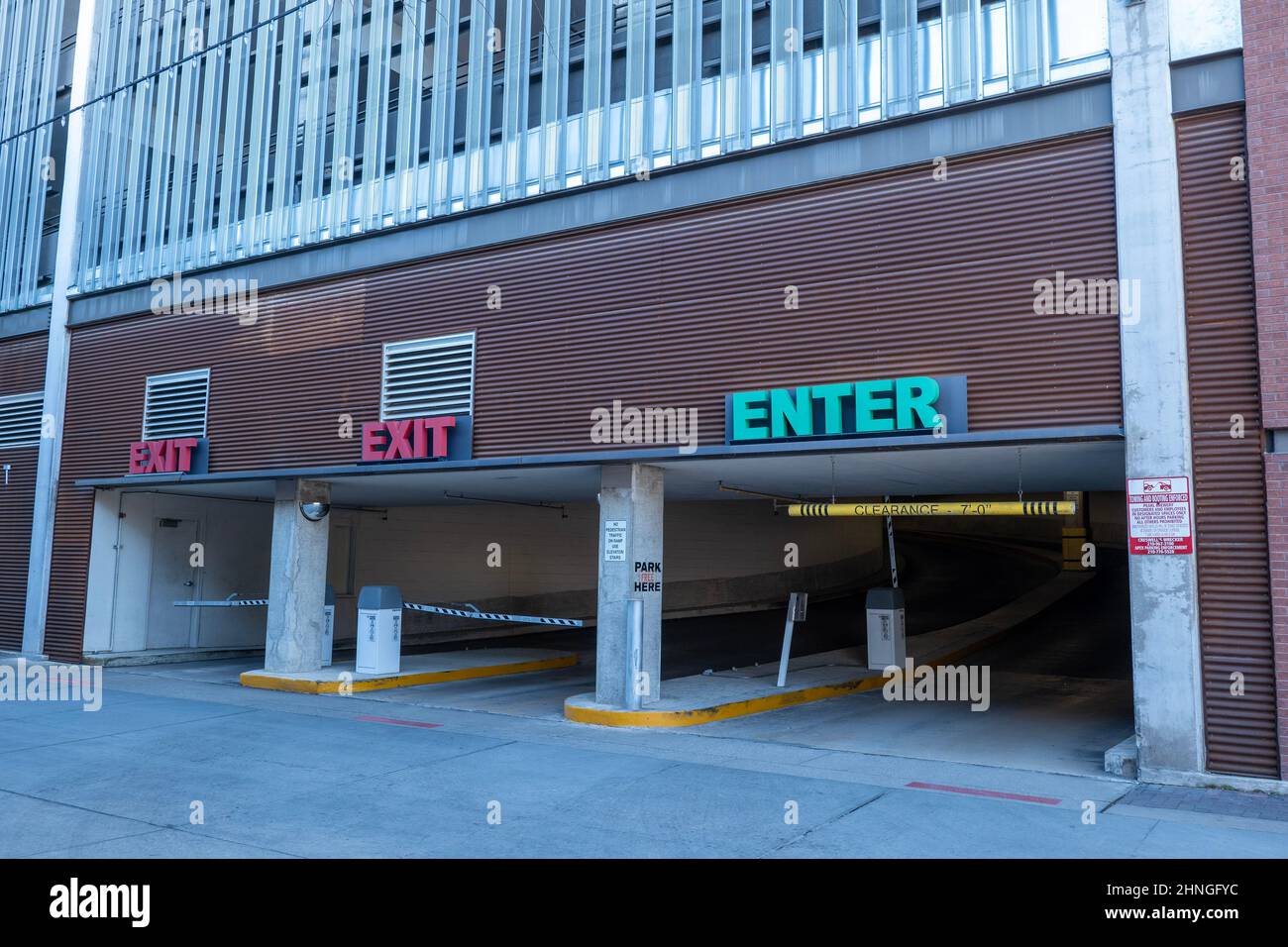 Two Parking Garage Ramp Entrance and Exits with blue and red signs over ...