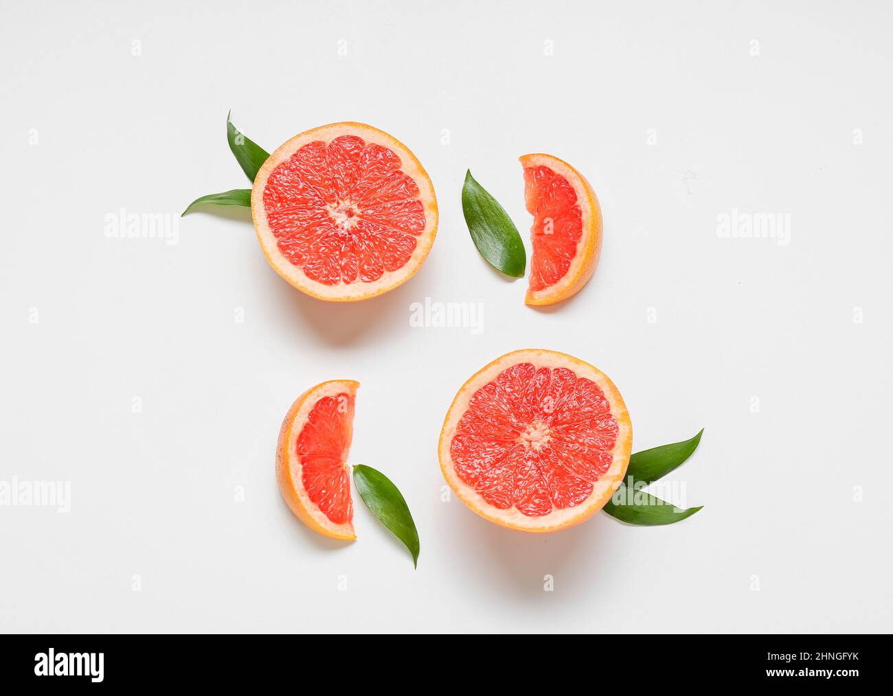 Fresh grapefruit pieces on white background Stock Photo - Alamy