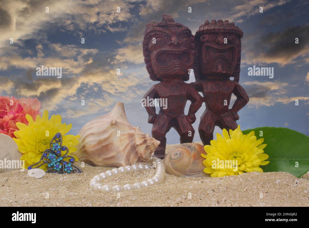 Tiki Statue on Sand With Flowers and Sea Shells. Beach Scenery Stock ...