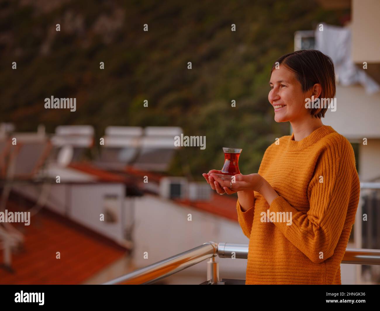 Woman drinking turkish tea from traditional turkish teacup and enjoys ...