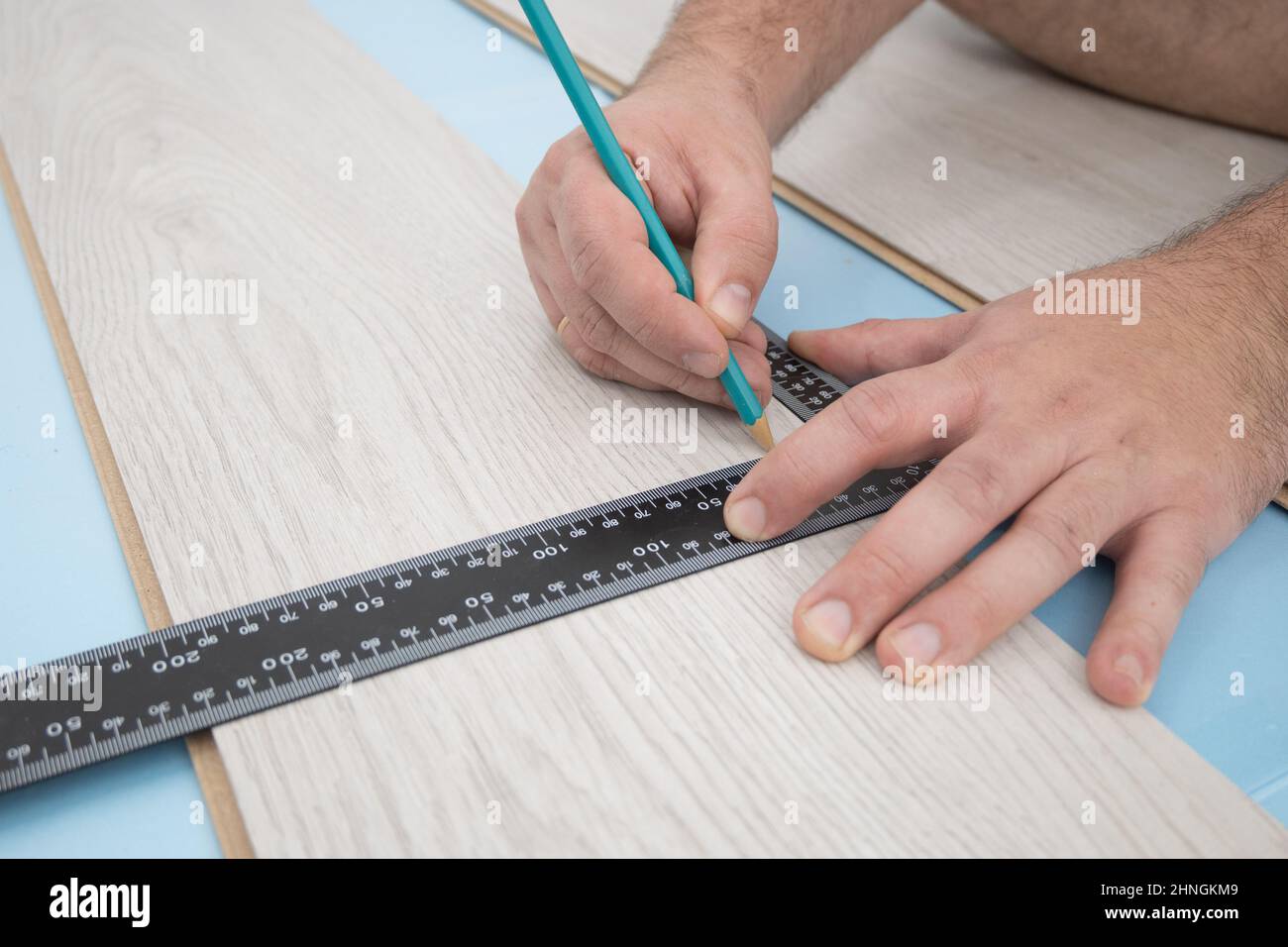 Floor renovation. Measuring before setting of the laminate floor Stock ...