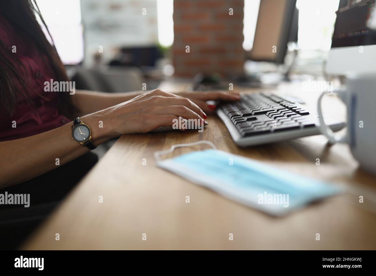 Female hands with a clock press the keyboard Stock Photo - Alamy