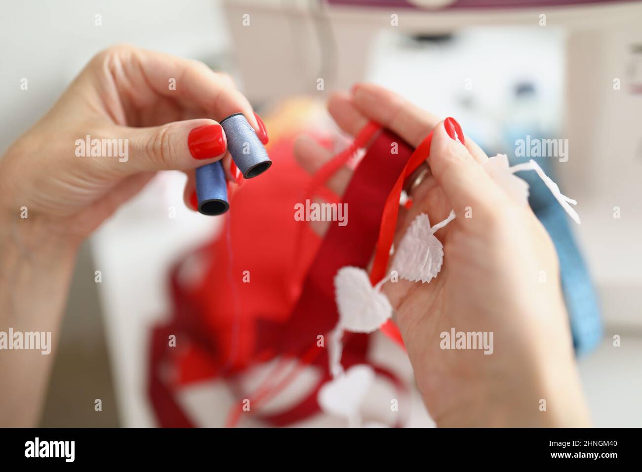 Female hands hold bright threads and ribbons Stock Photo - Alamy