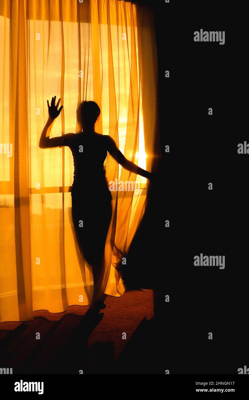 Woman face behind curtains hi-res stock photography and images - Alamy