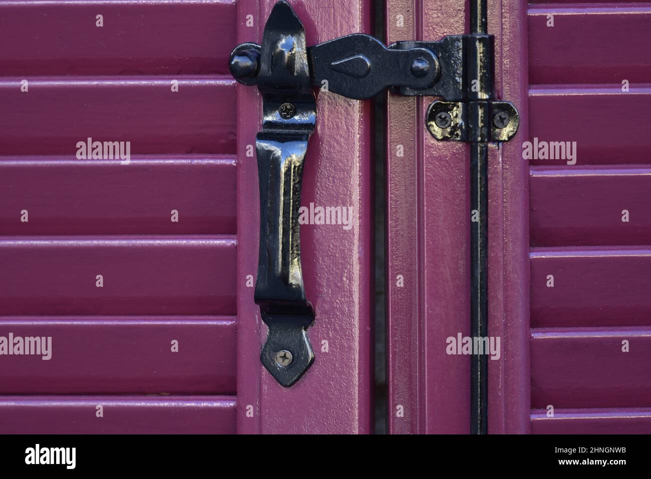 Traditional magenta wooden window shutter with a metal latch Stock ...
