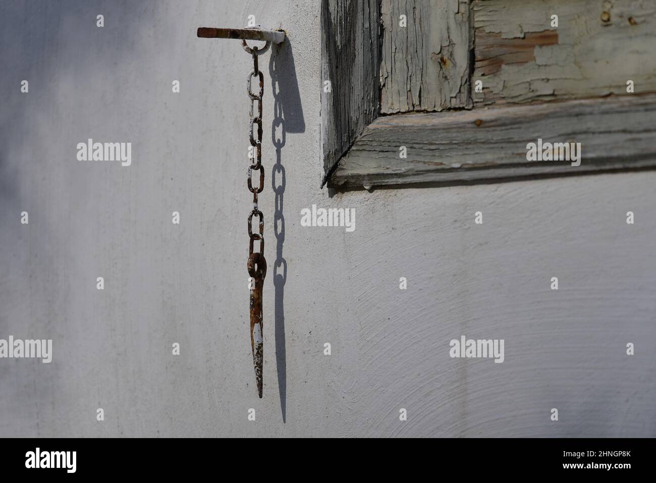 Old rural house weathered grey wooden window shutters with a rusty ...