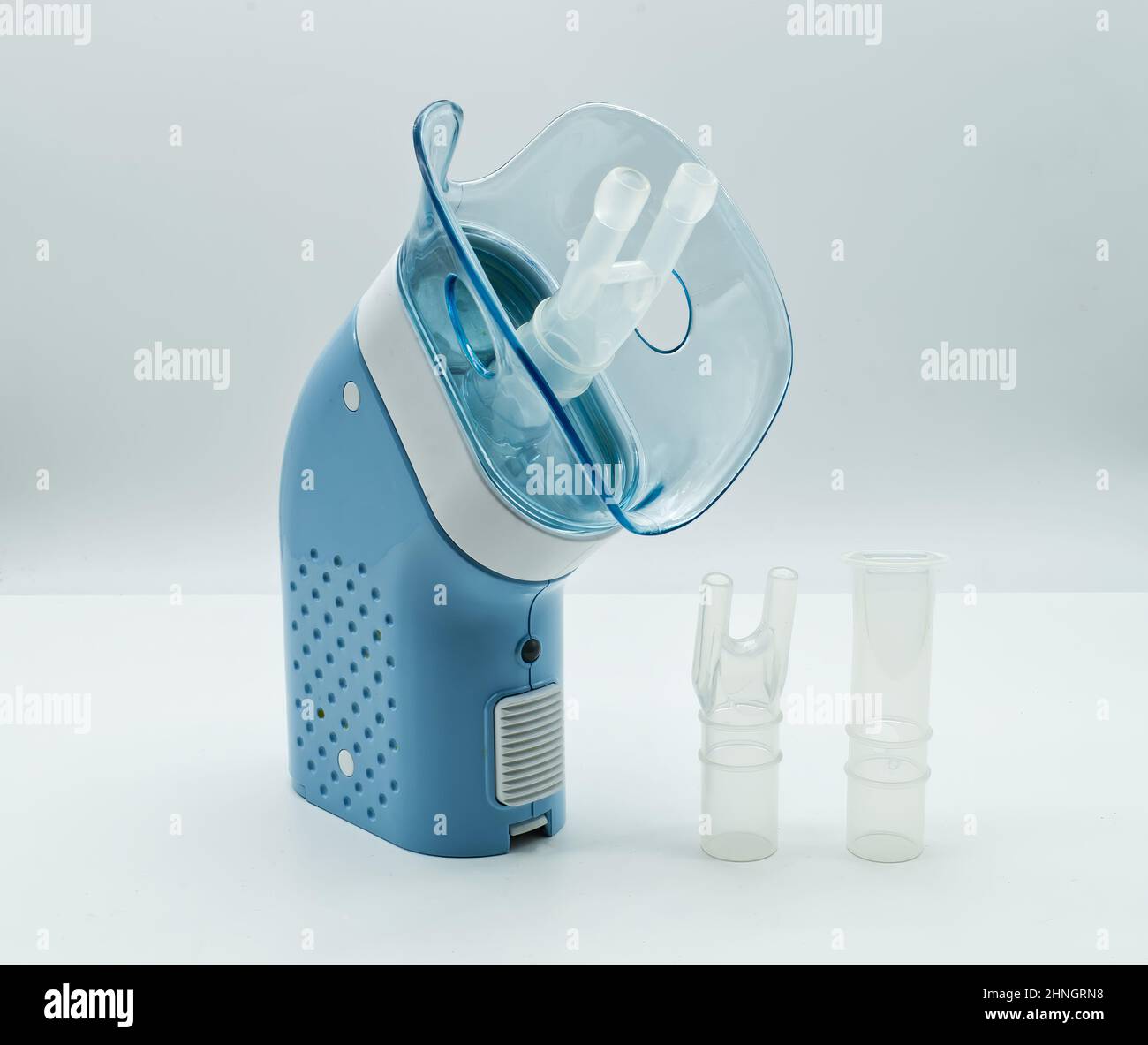Portable compressor nebulizer on white table. Medical equipment for ...