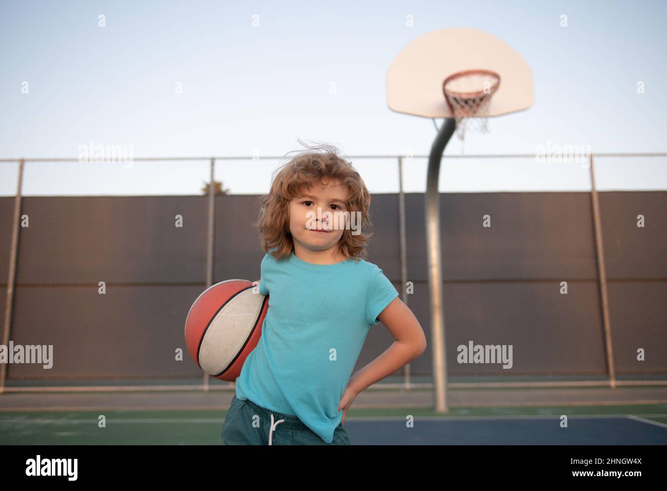 Child boy preparing for basketball shooting. Young kid posing with a ...