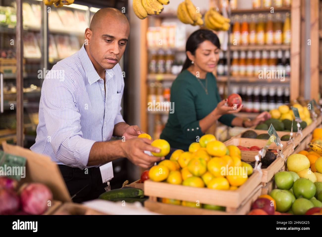 Male consumer choosing tangerines in supermarket Stock Photo - Alamy