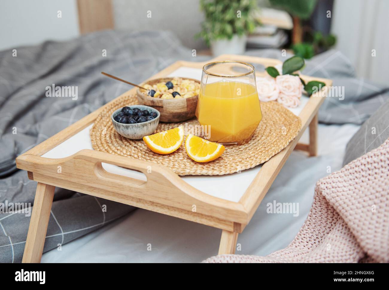 Healthy breakfast. Orange juice, fruits and bowl with granola on a tray ...