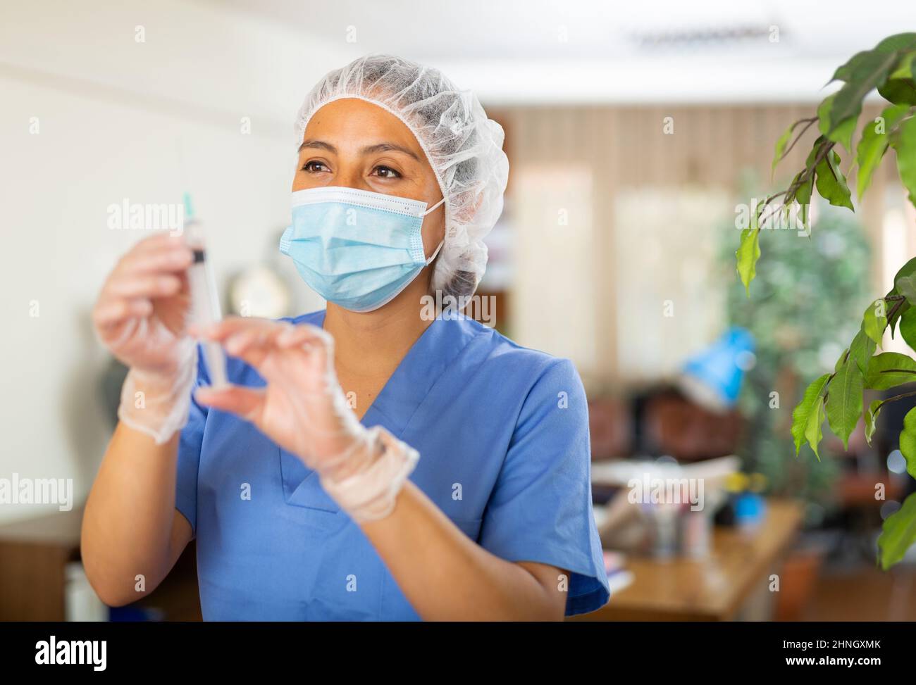 Young woman doctor assistant preparing syringe for injection Stock ...