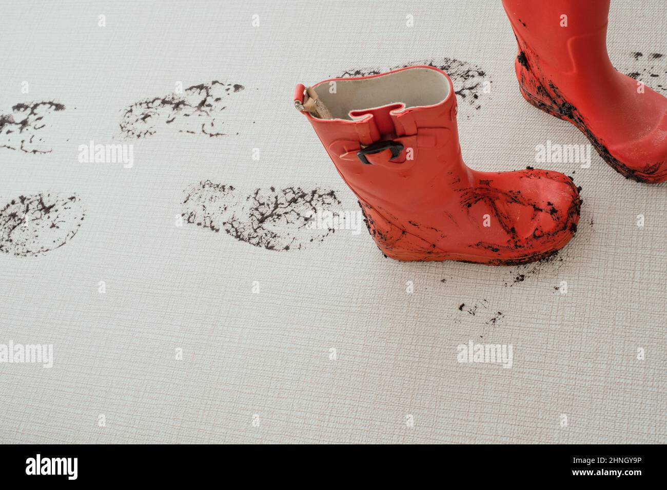 Close up of a pair of rubber boots with dirt after a walk lying on the ...