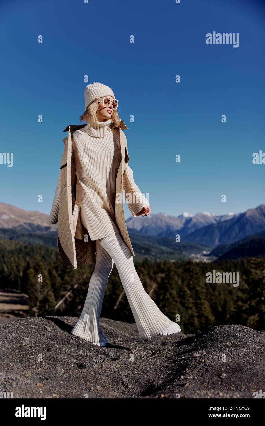 tourist in autumn clothes stands on a rock blue sky lifestyle Stock ...