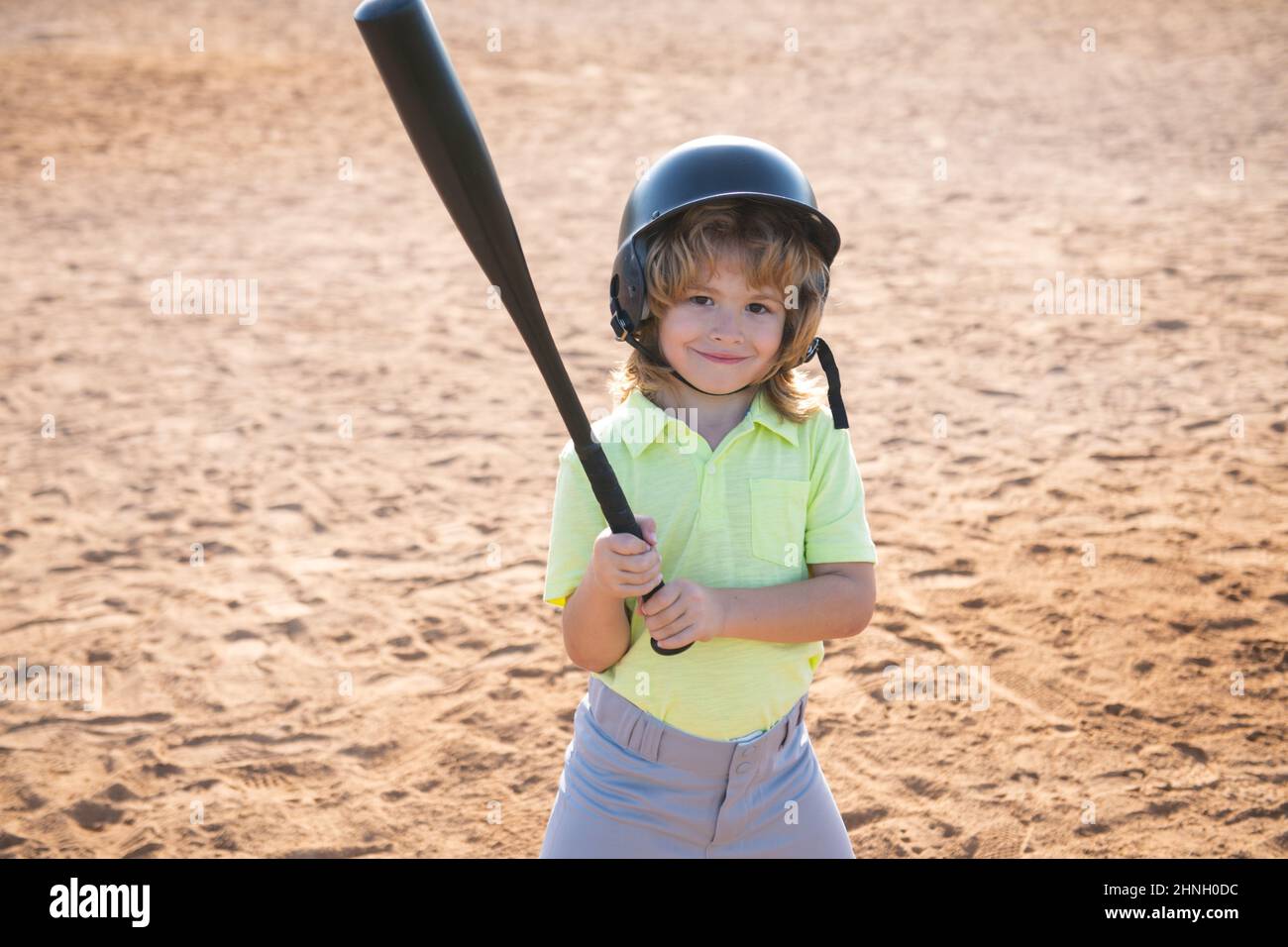 Kid holding a baseball bat. Pitcher child about to throw in youth ...