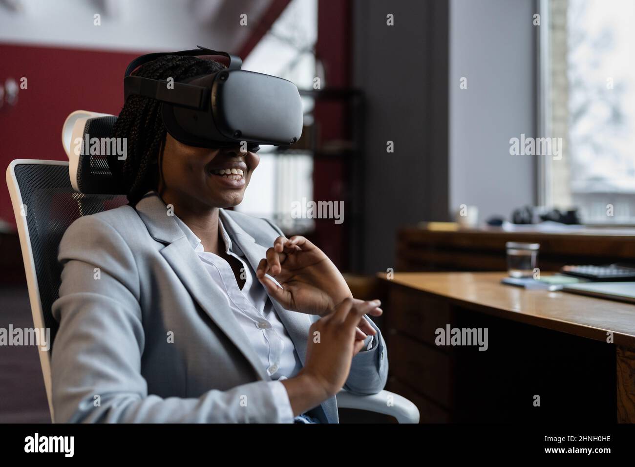 VR in workplace. Smiling african female employee during corporate ...