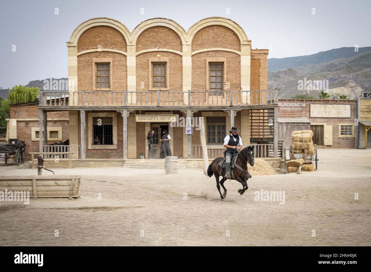 Wild west movie set with men fighting and a galloping horse Stock Photo ...