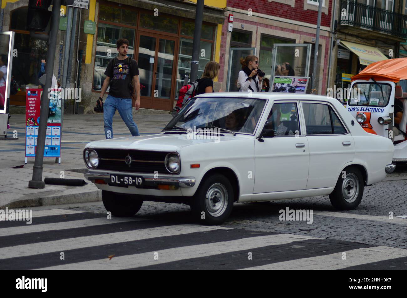 Shot of the white classic Datsun Sunny B110 1200 in the street of Porto ...