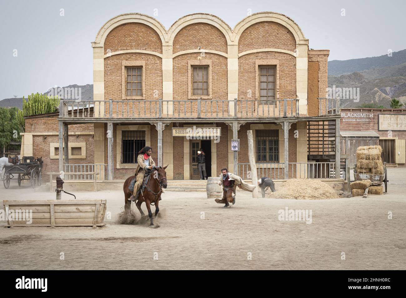 Wild west movie set with men fighting and a galloping horse Stock Photo ...