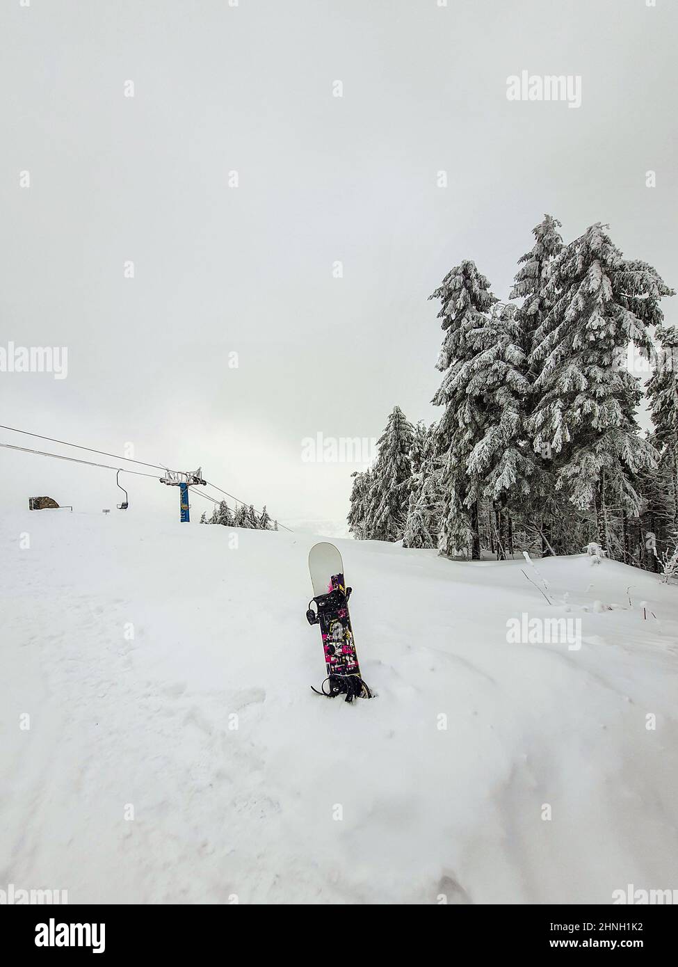 snowboard stick out from the snow ski resort Stock Photo - Alamy