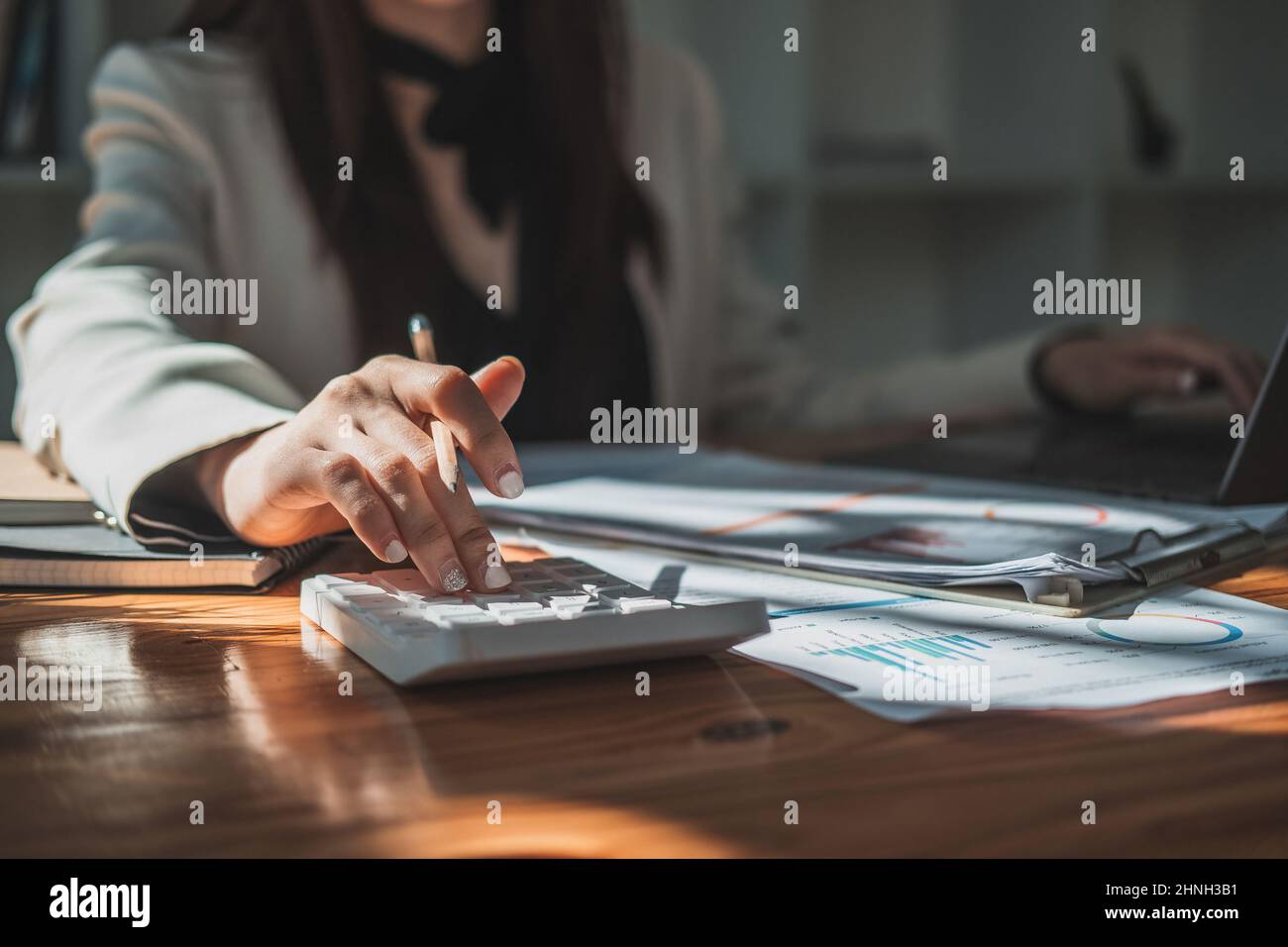 Close up of business asian woman or accountant hand holding pen working ...