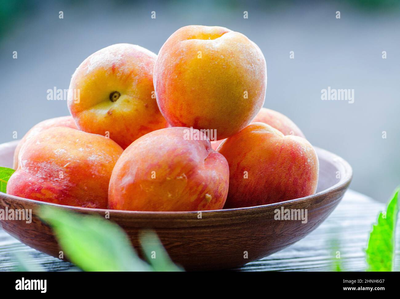 ripe peaches in a bowl on a table in the street Stock Photo - Alamy