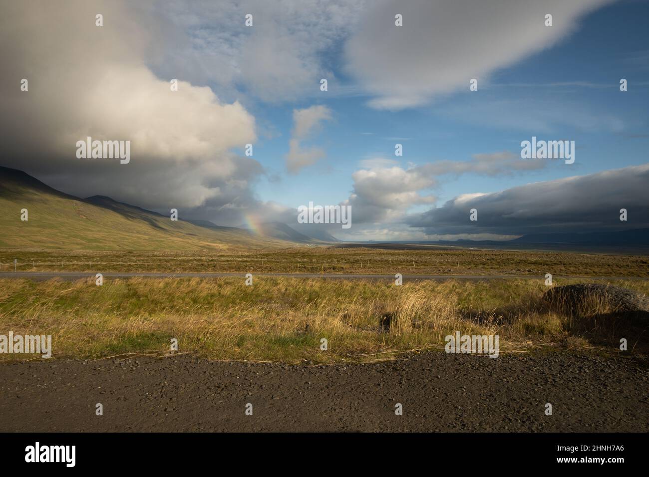 Windy and stormy weather with majestic clouds and rainbow in Iceland ...