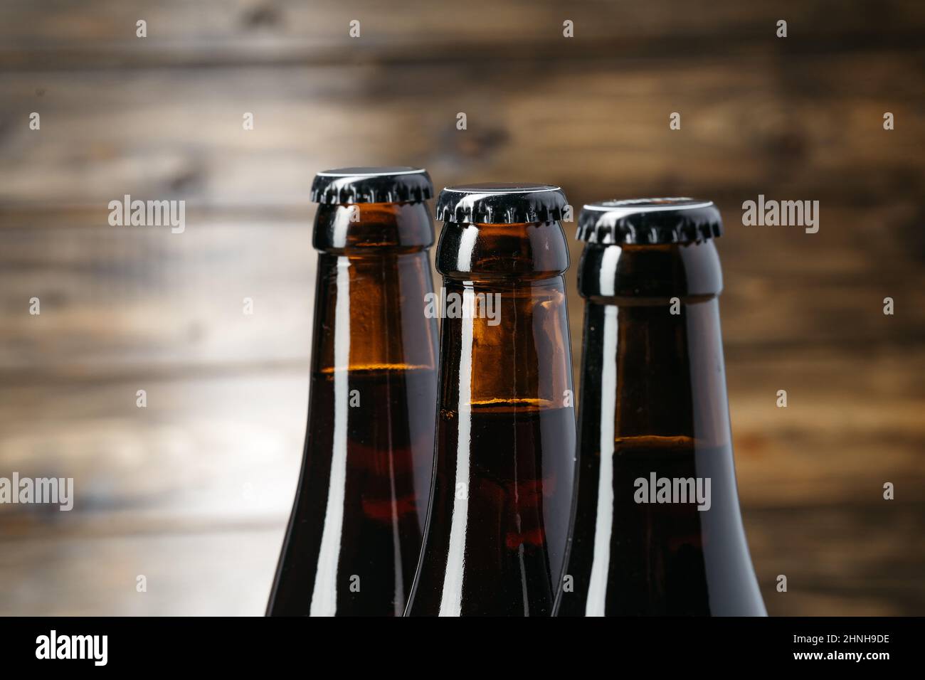 Beer bottle on a brown wooden table flat lay background with a copy ...