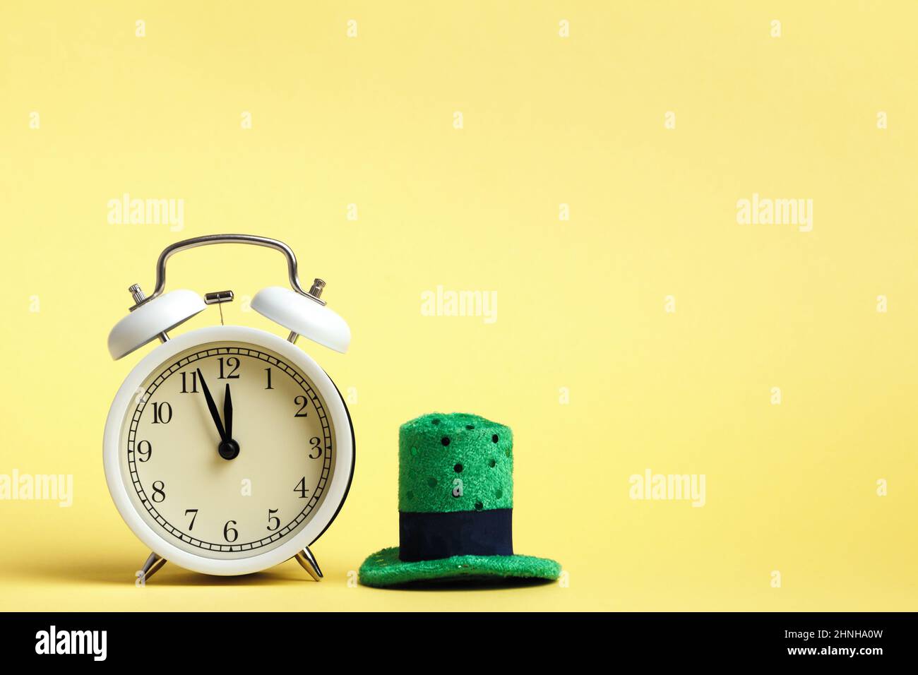 St. Patrick's Day celebration concept. Alarm clock and green leprechaun ...