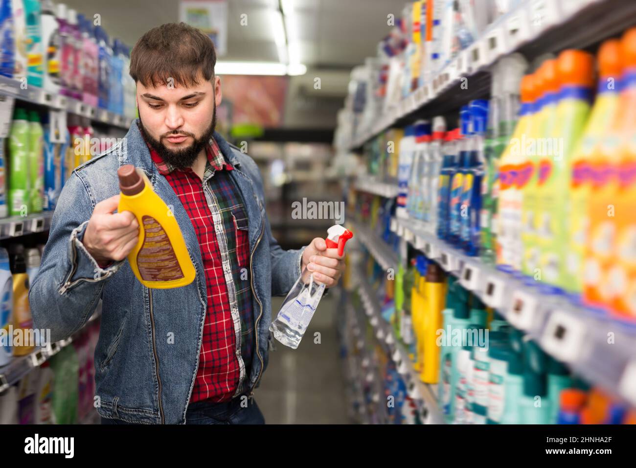 Adult young man making purchases in store Stock Photo - Alamy
