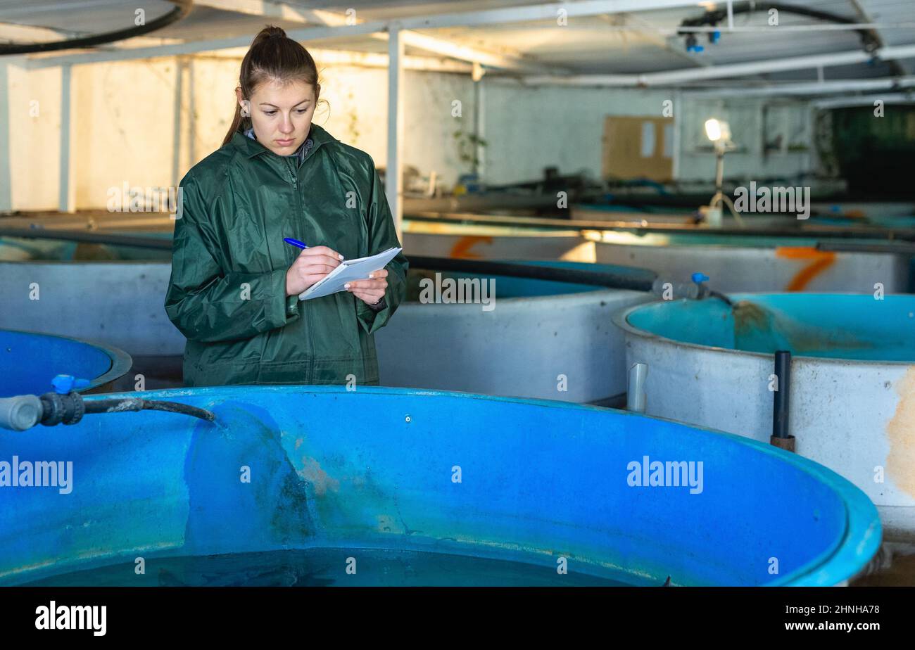 Female in fish breeding incubator Stock Photo - Alamy