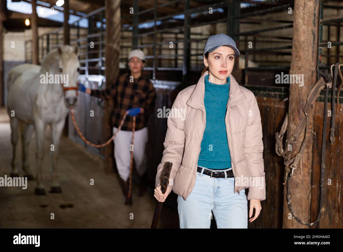Woman horse rancher carrying working tool in hand Stock Photo - Alamy