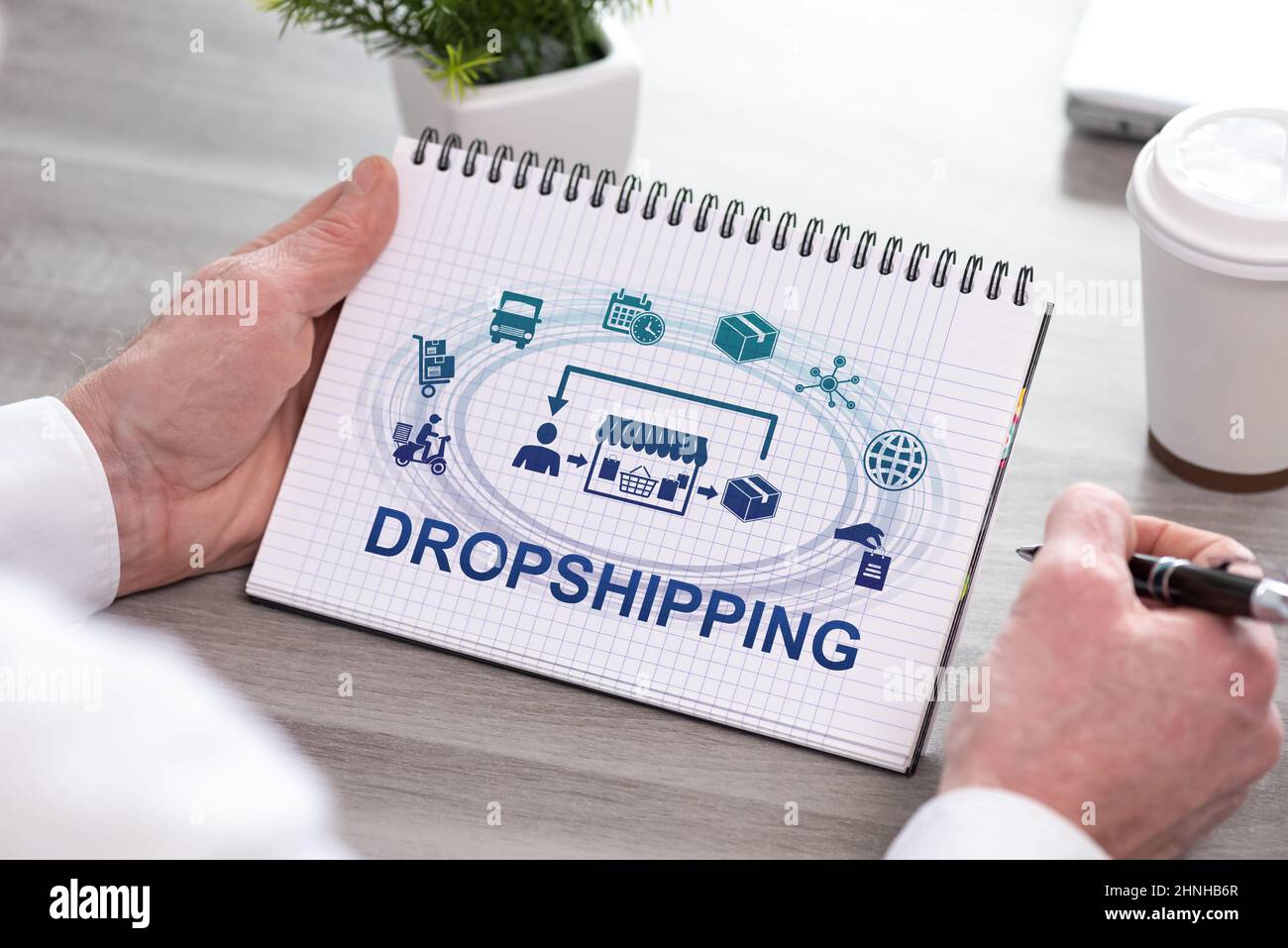 Hand holding a notepad with dropshipping concept Stock Photo - Alamy