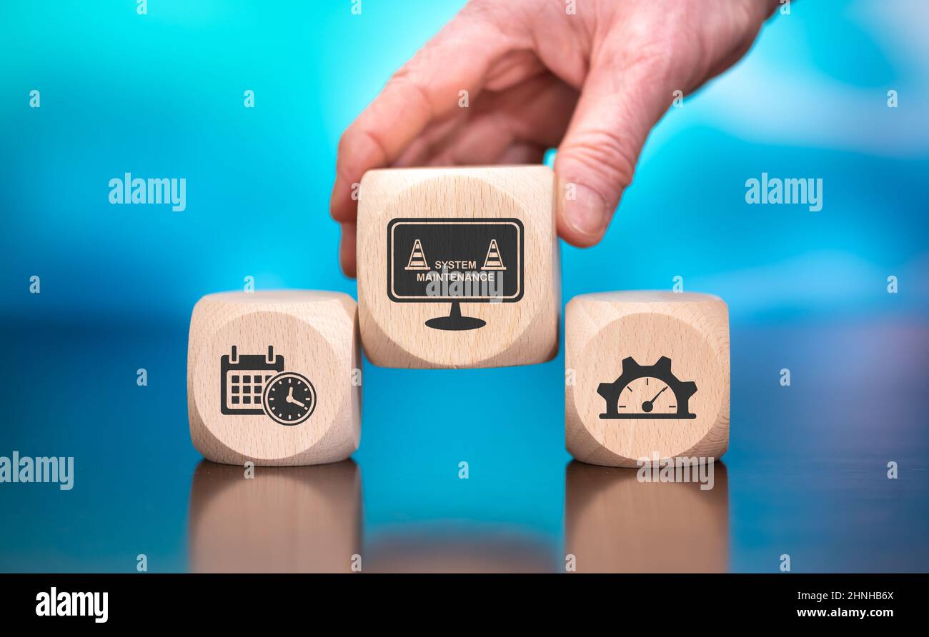 Wooden blocks with symbol of system maintenance concept on blue ...