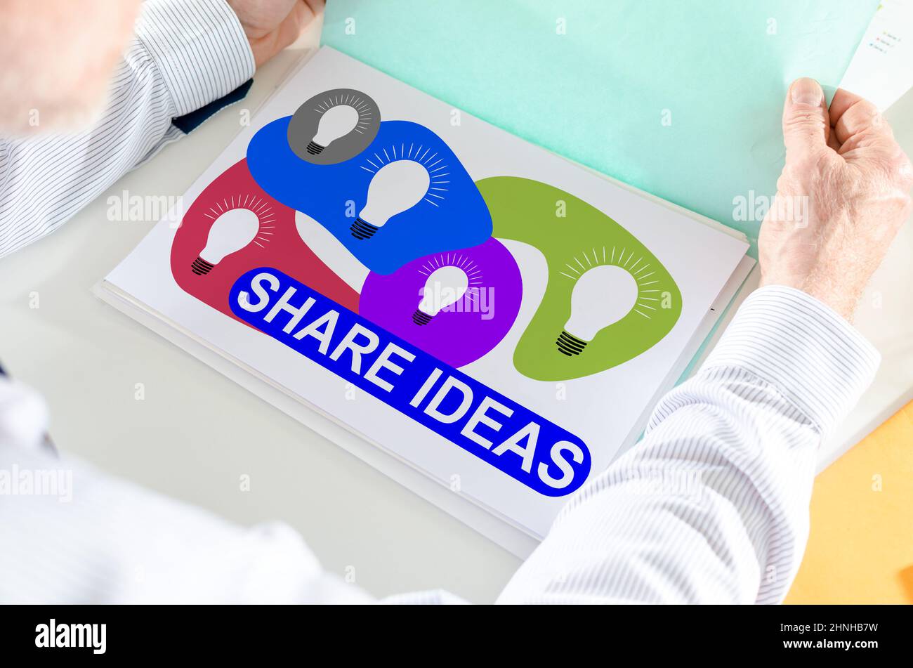 Man holding a file with share ideas concept Stock Photo - Alamy