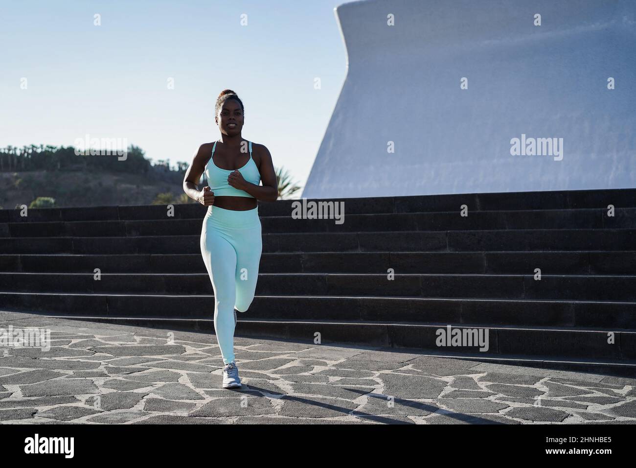 Fit african woman running outdoor - Focus on face Stock Photo - Alamy