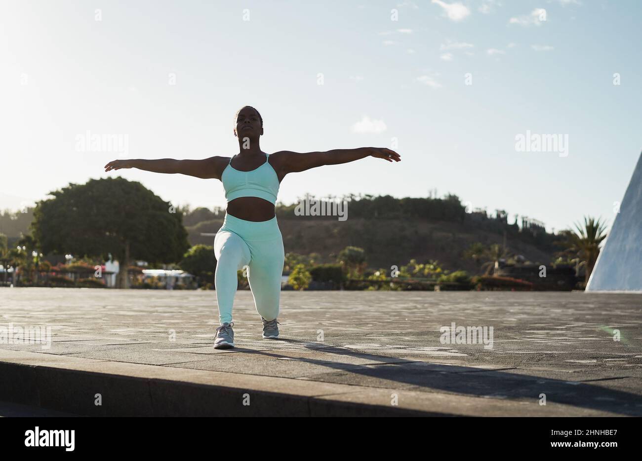 Fit african woman doing sport stretching exercise outdoor - Soft focus ...